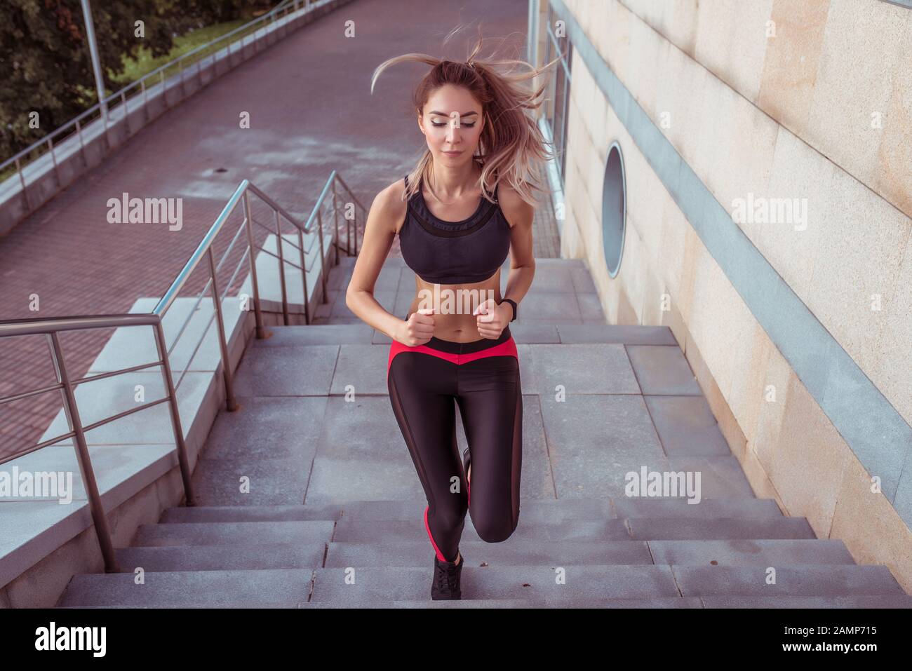 Beautiful girl jogging morning city running jump, staircase background ...