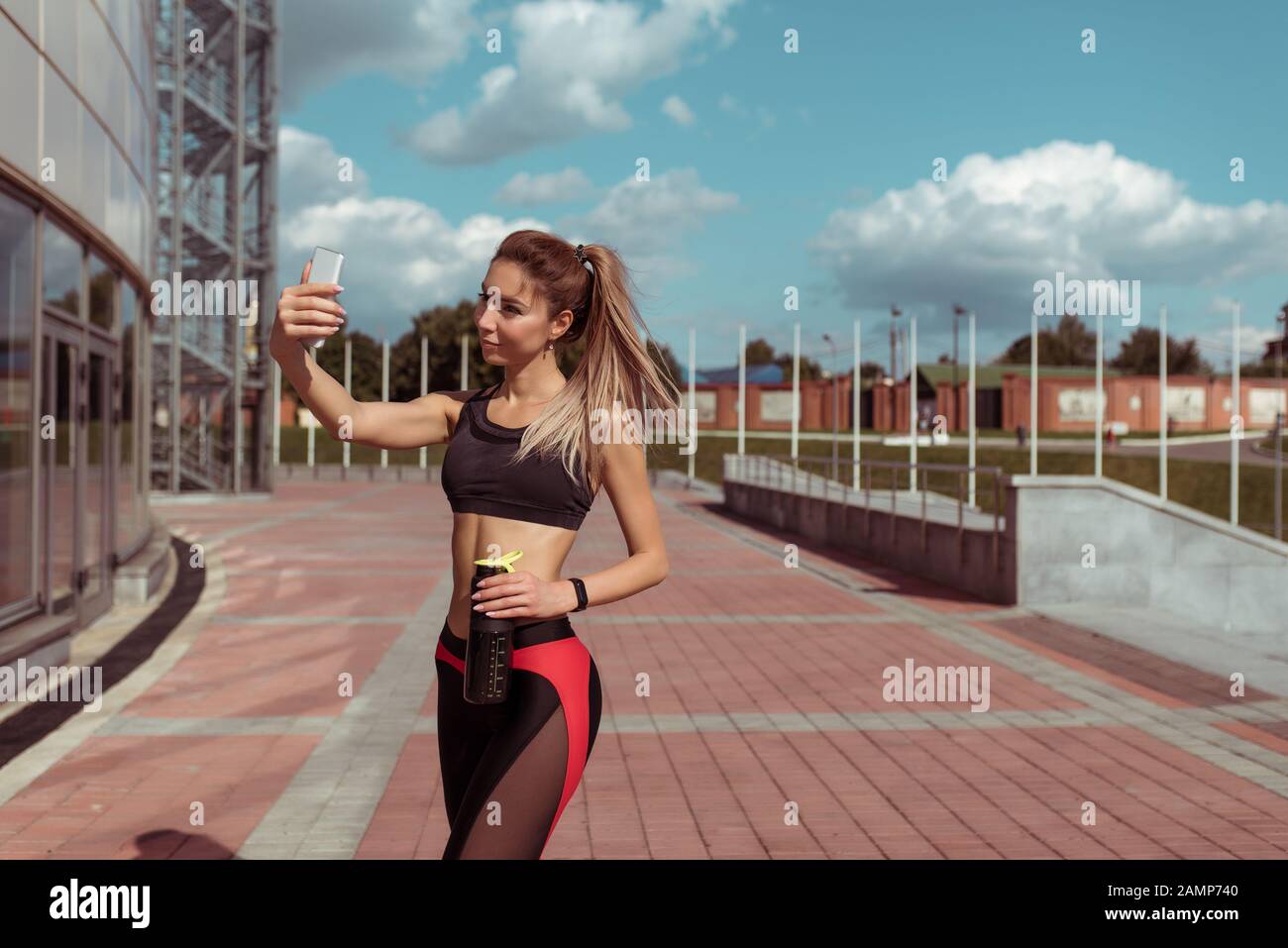 Beautiful girl photographs selfie phone, summer city, morning afternoon ...
