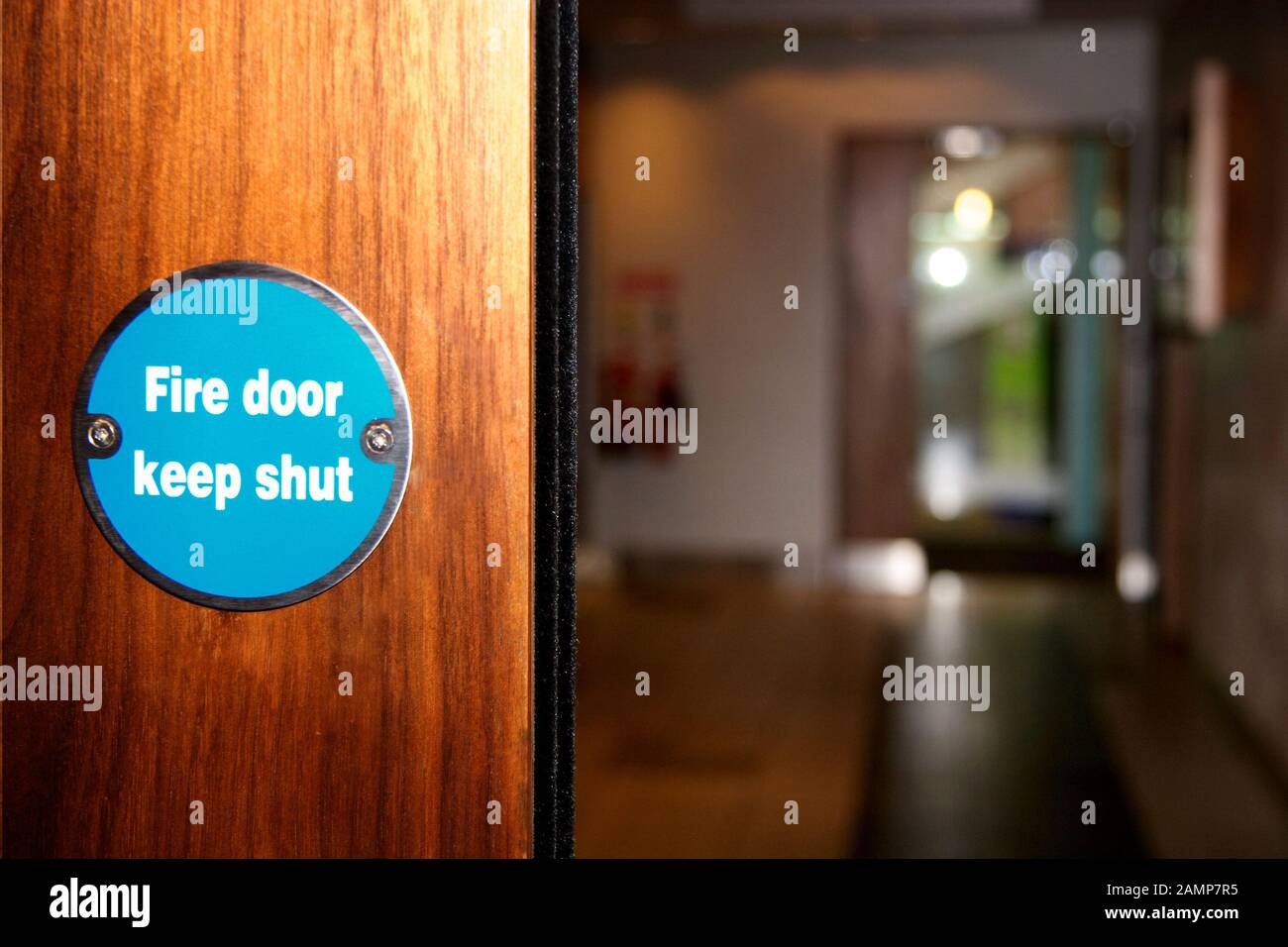 Fire door sign on a wooden door in a public building Stock Photo - Alamy