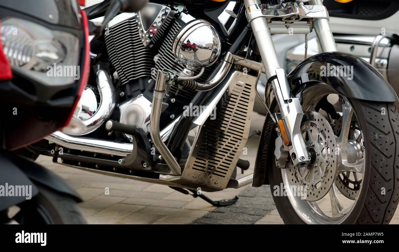 Shiny silver motorcycle with protective windshield standing outdoors ...
