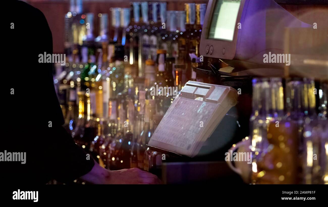 Restaurant worker typing on cash register, accepting order from ...