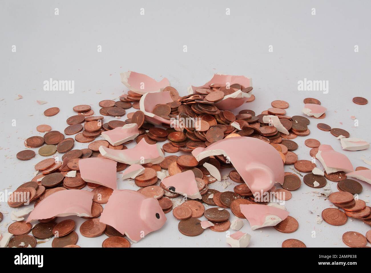 A smashed piggy bank with scattered euro coins Stock Photo - Alamy