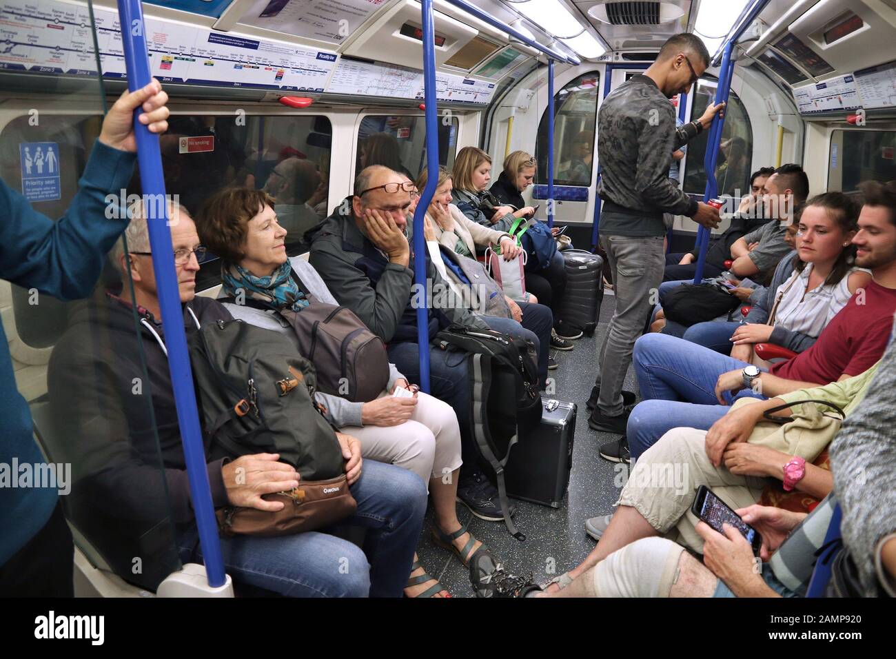 LONDON, UK - JULY 14, 2019: Passengers ride London Underground train ...