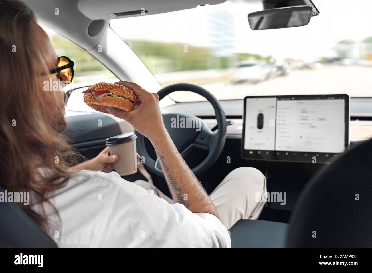 Guy eating food in car hi-res stock photography and images - Alamy
