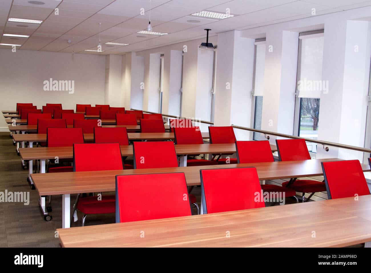 An empty lecture or seminar room with red chairs Stock Photo - Alamy