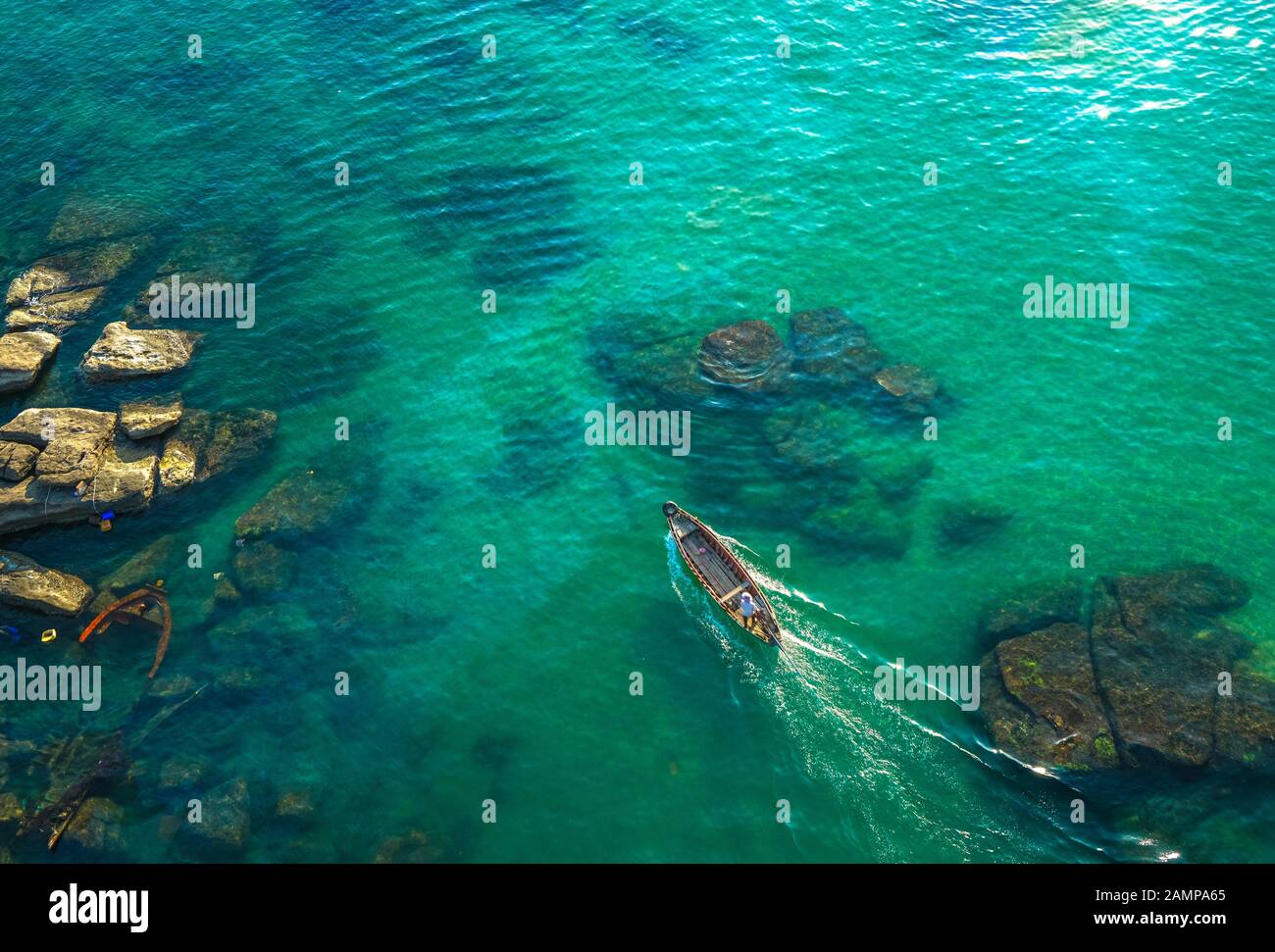 Lone man on a boat in the tropical sea Stock Photo - Alamy