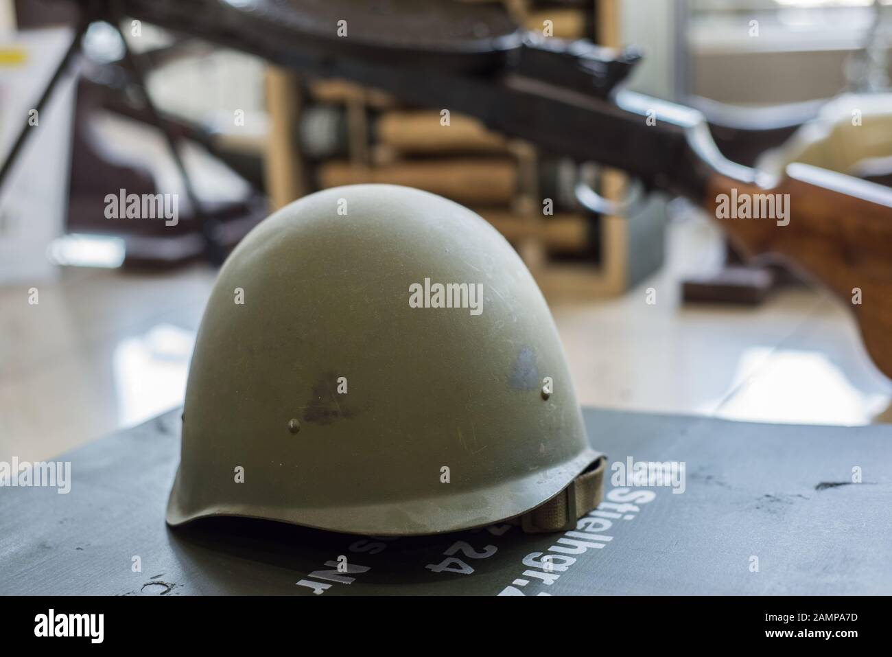 green military helmets, stand in the arms store on the background of ...