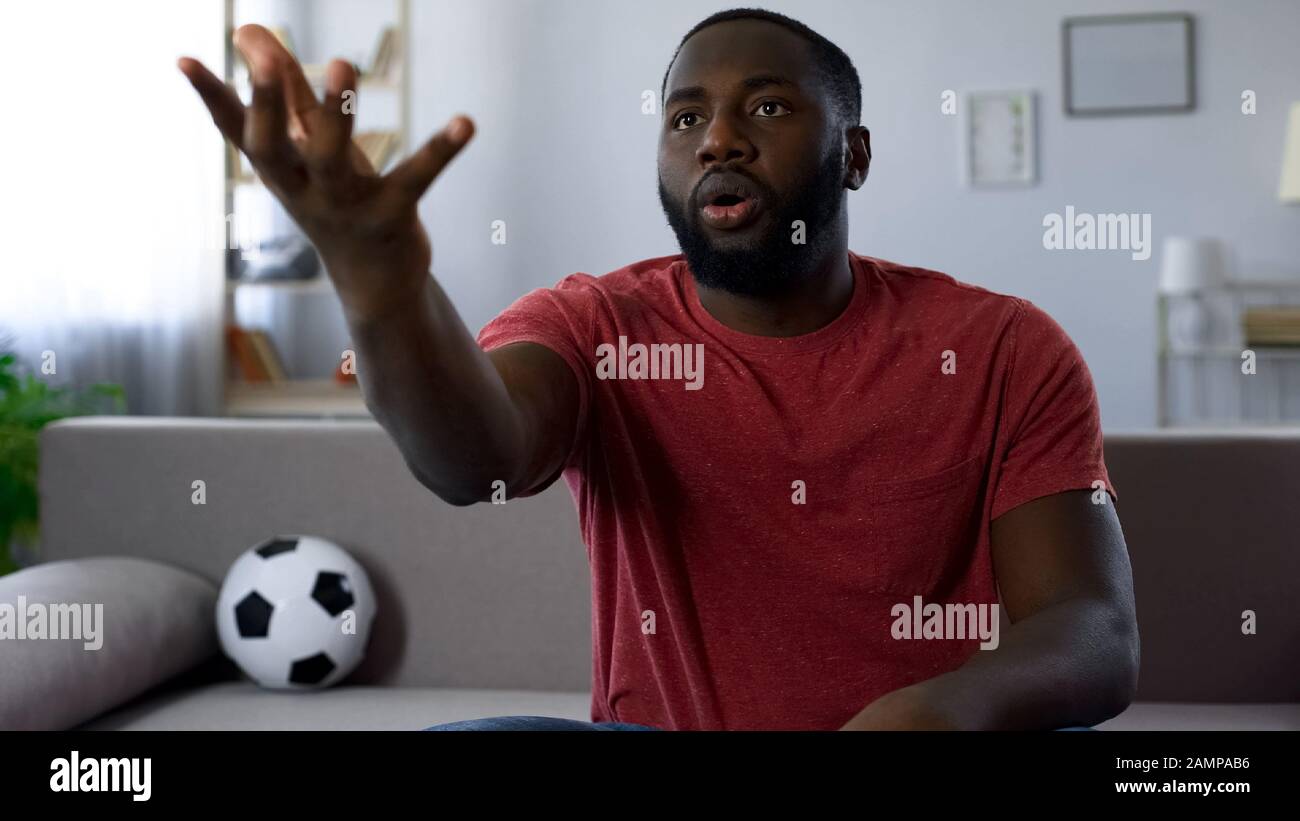 Afro-american fan criticizing game of players, football expert, bad ...