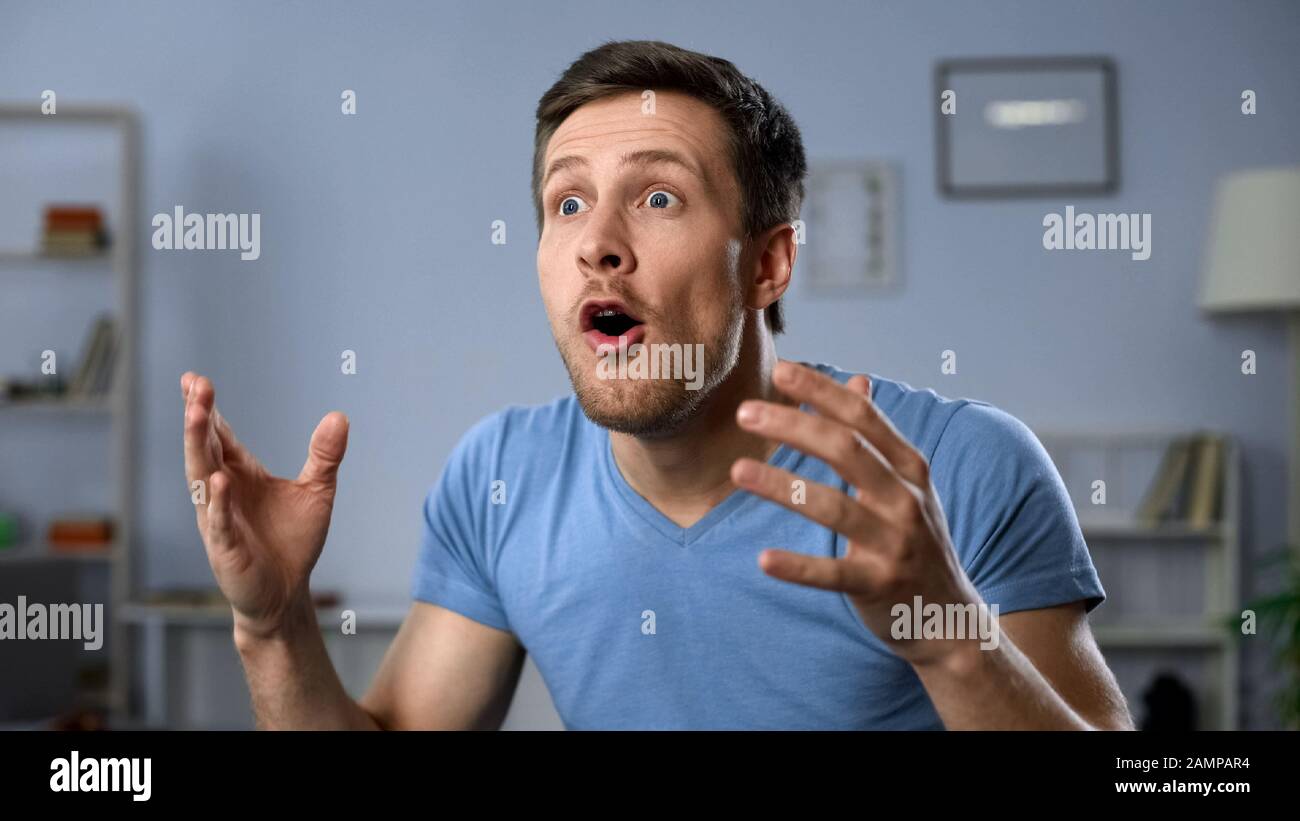 Funny face of sports fan watching final game at home, happy for ...