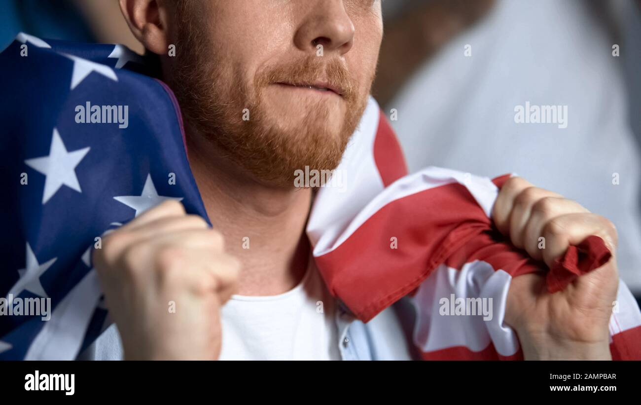 Happy male waving American flag, watching sports competition, cheering ...