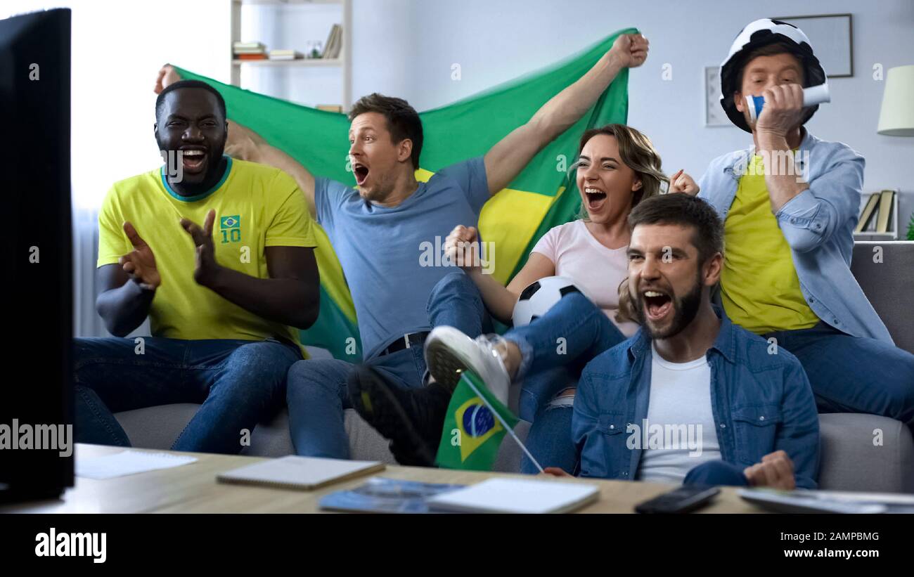 Brazilian friends celebrating brazil flag hi-res stock photography and ...
