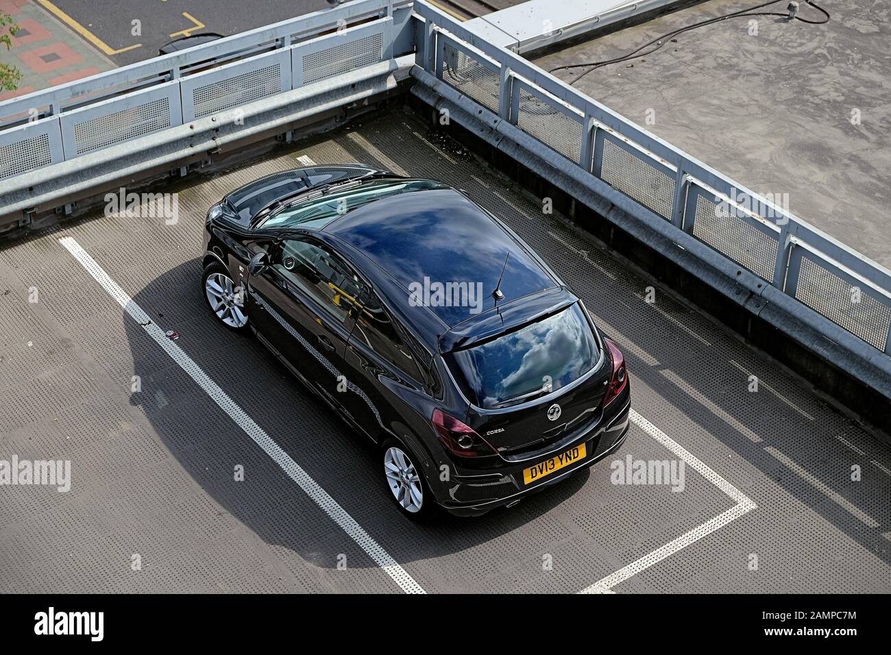 Overhead shot of a black Vauxhall hatch back parked on the top deck of ...