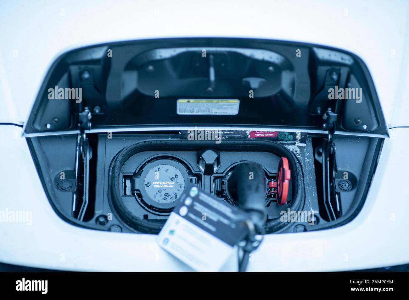 Nissan LEAF, plugged into charging port, in The Hague, The Netherlands ...