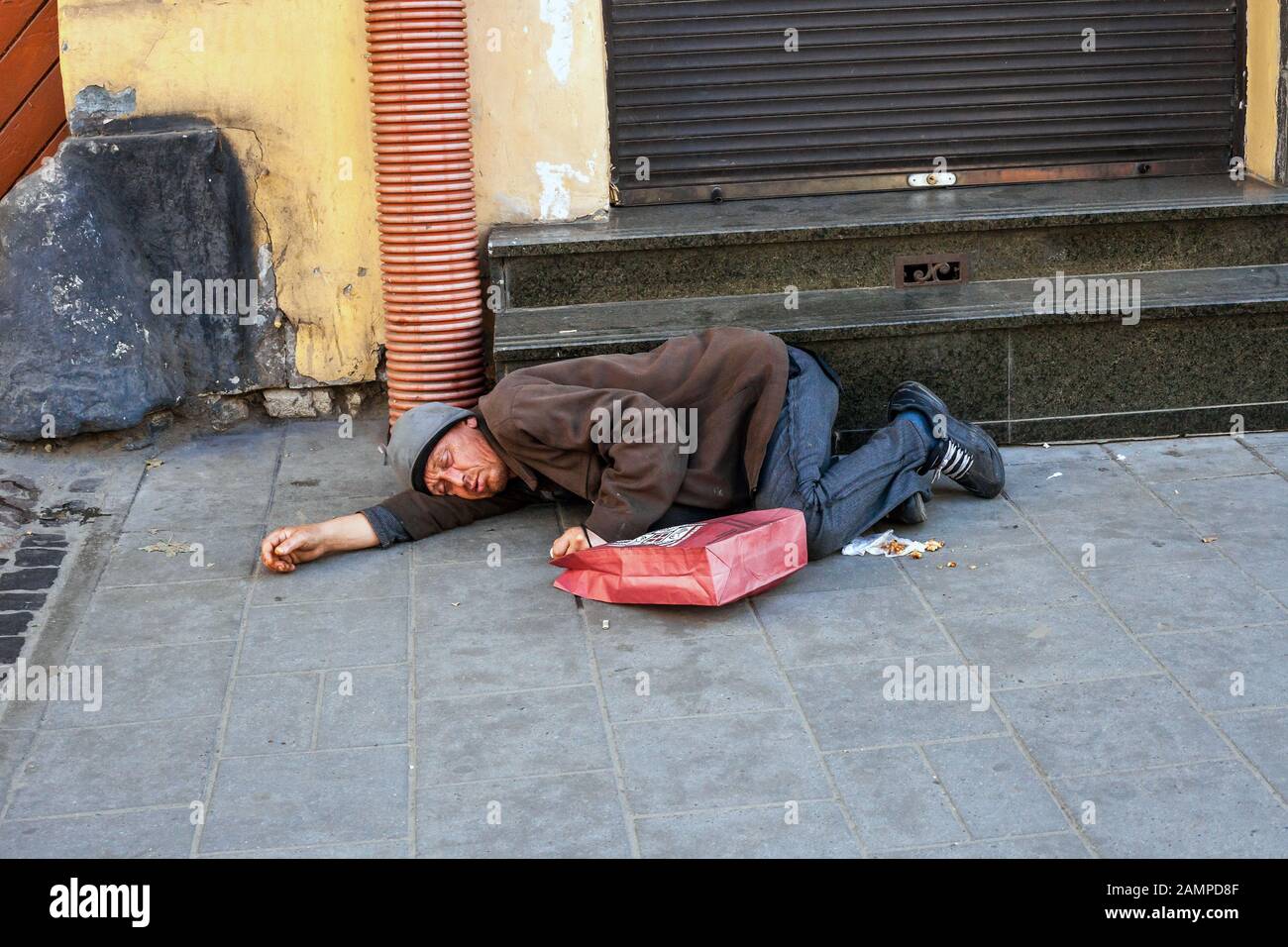 Lviv, Ukraine - 26 October 2019: Drunken homeless man sleeping on city ...