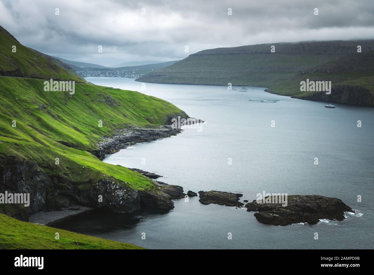 Dramatic view of green hills of Vagar island and Sorvagur town on ...