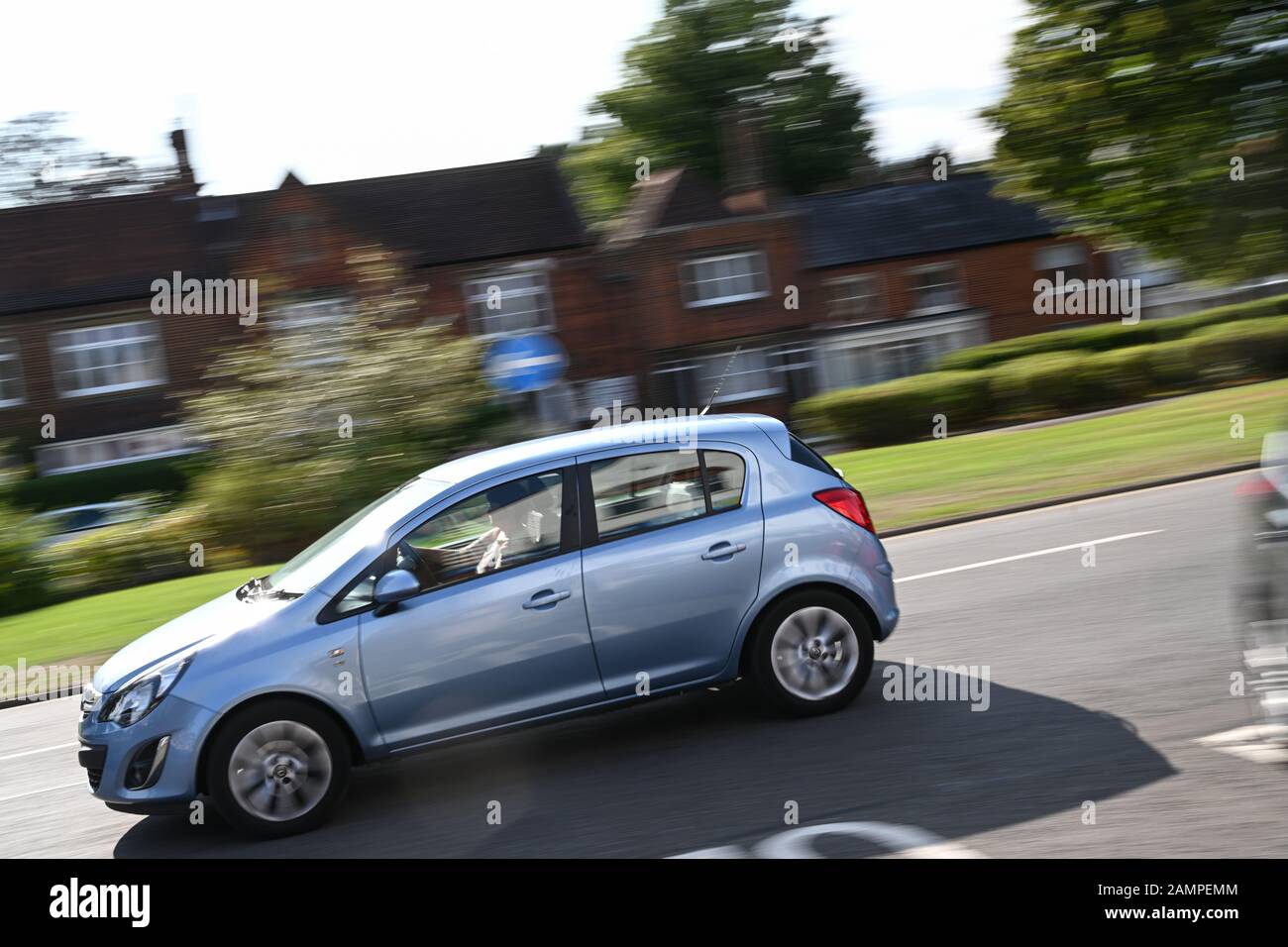 Older woman driving a car down a suburban road Stock Photo - Alamy