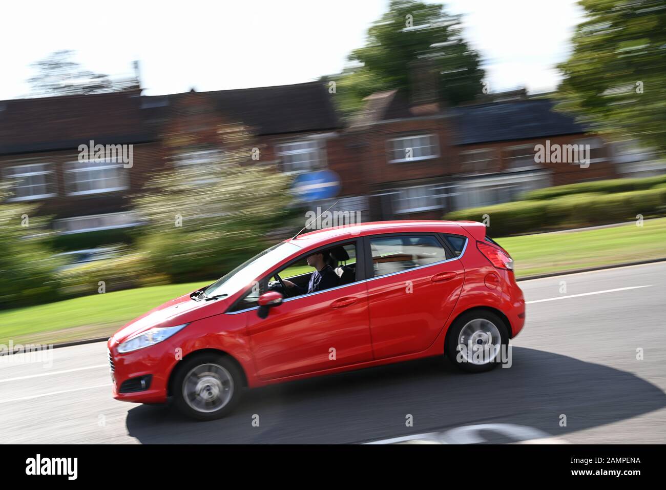 Red car driving slow on hi-res stock photography and images - Alamy