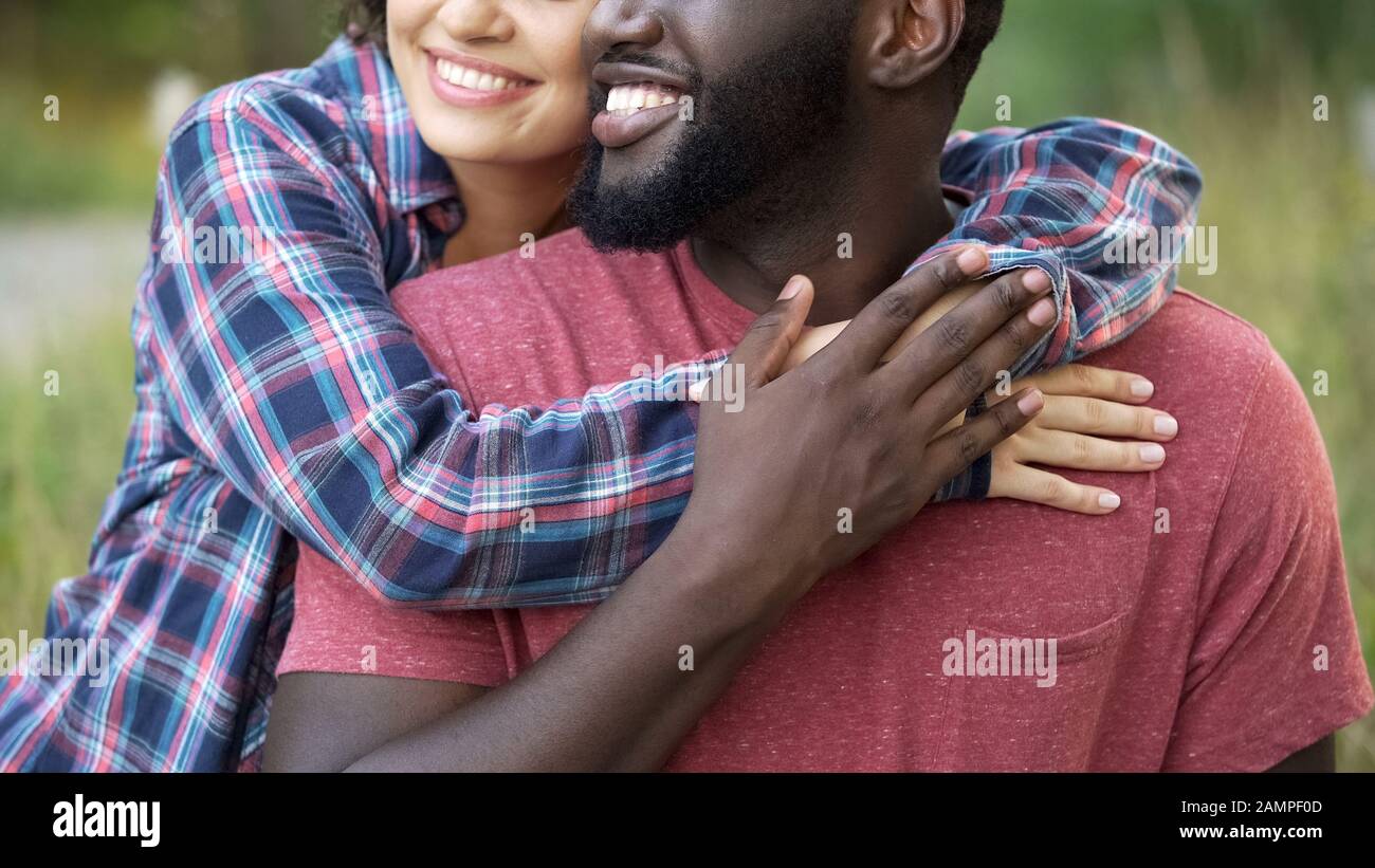 Cheerful couple tightly hugging posing to camera, healthy smiling ...