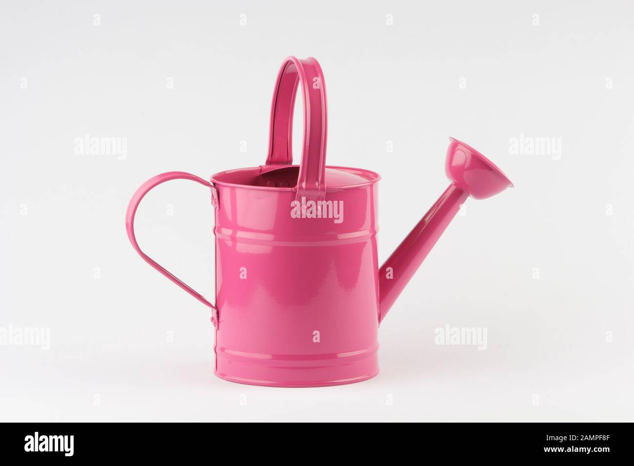 Pink watering can isolated on a white background Stock Photo - Alamy