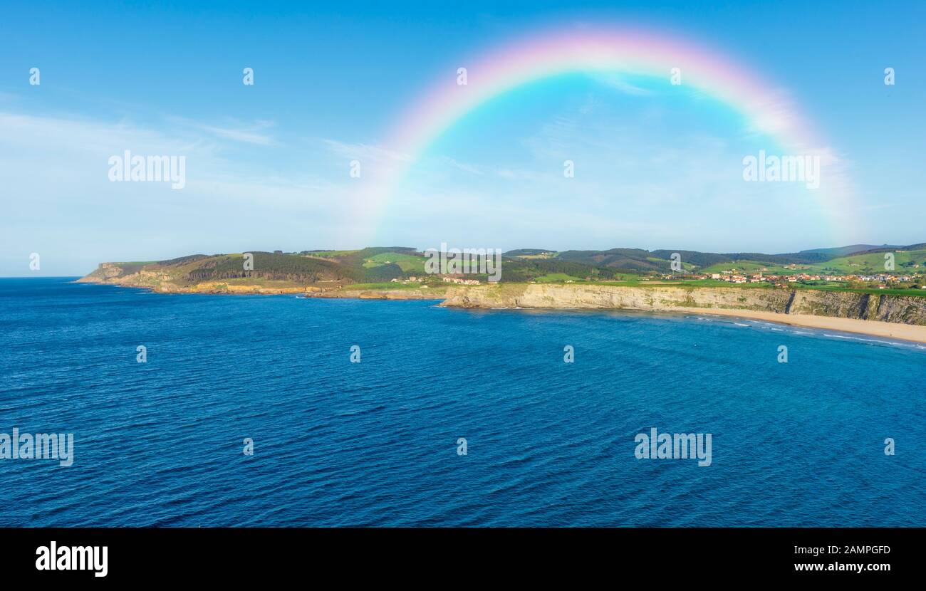 Mounts with the rainbow on a beach in Cantabria, Spain Stock Photo - Alamy