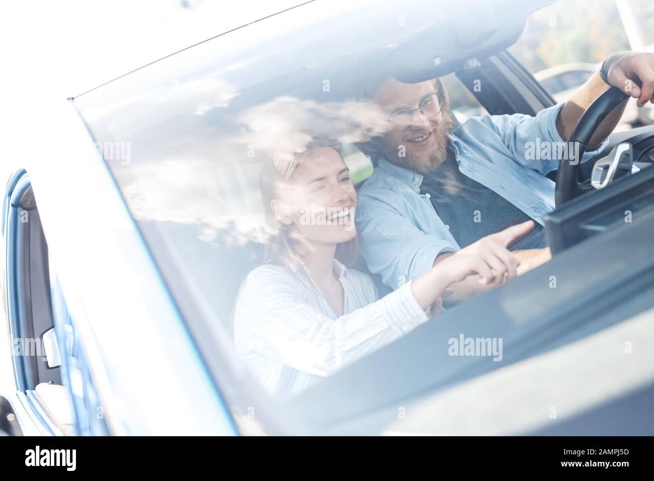 Transportation. Young couple traveling by electric car boyfriend ...