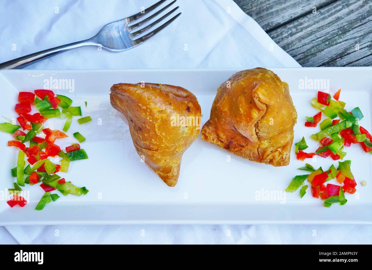A platter with crispy vegetable samosa turnovers at an Indian ...