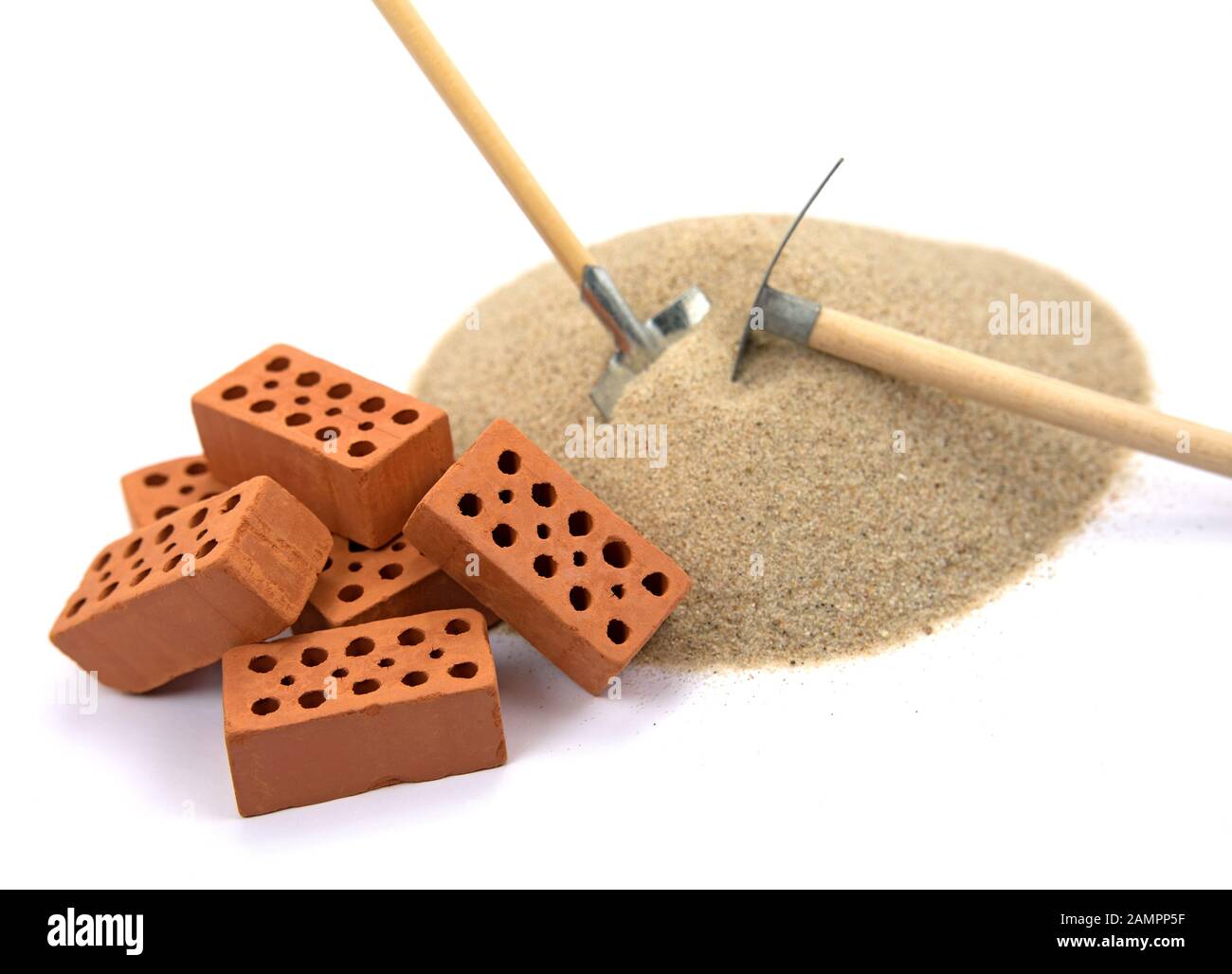 Bricks and building sand against a white background Stock Photo - Alamy