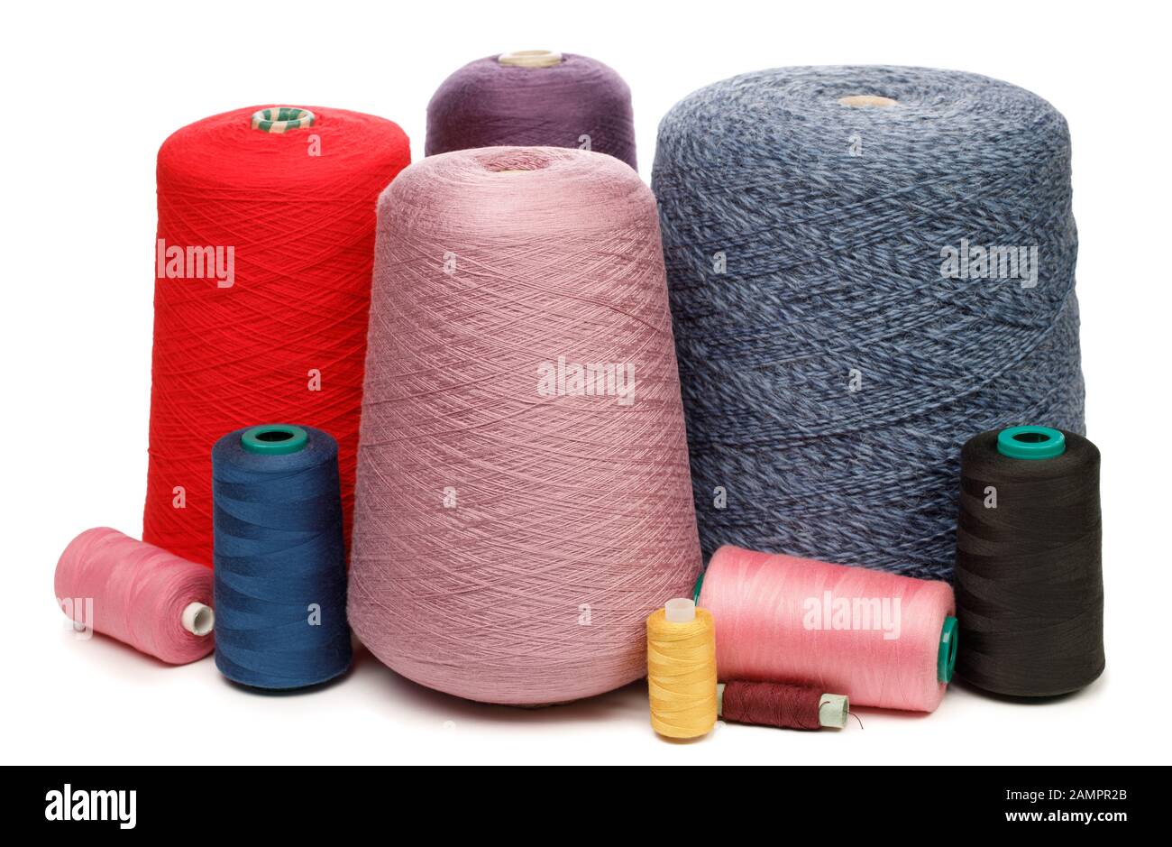 Cones and spools of synthetic or cotton threads on white background ...
