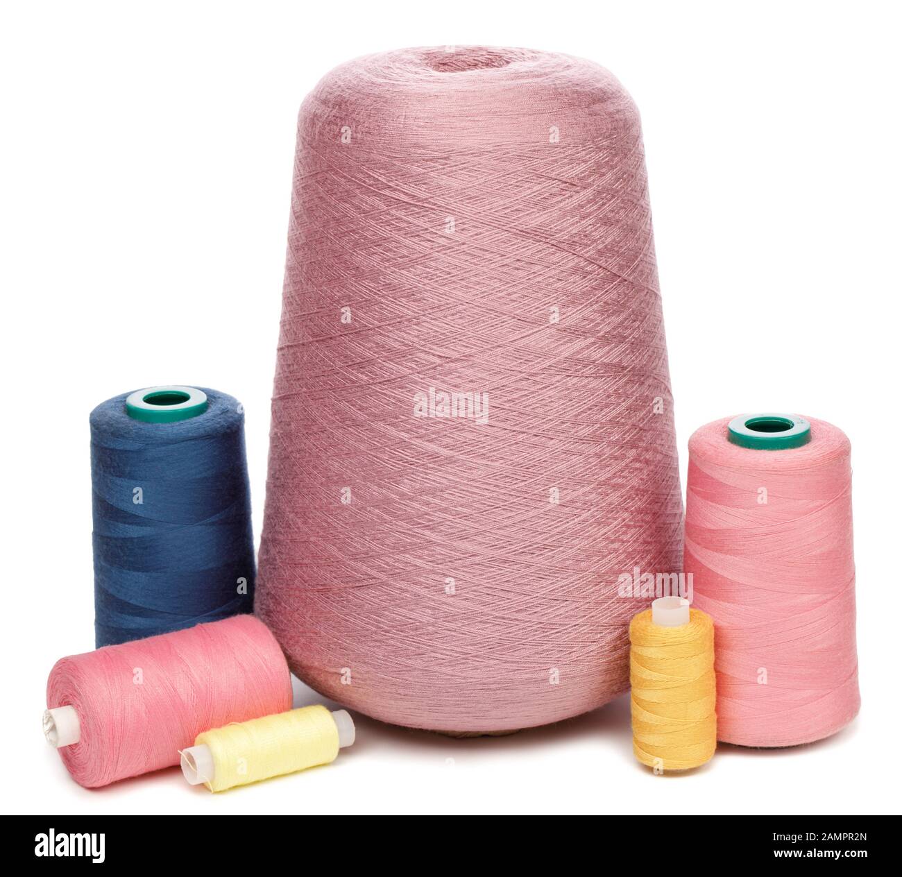Cones and spools of synthetic or cotton threads on white background ...
