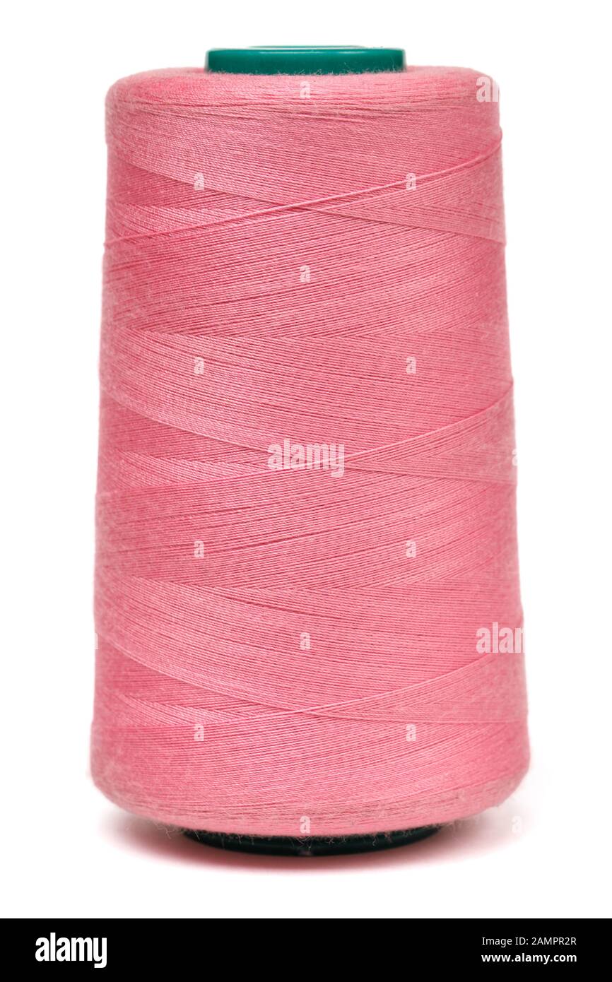 Spool of pink synthetic or cotton threads isolated on white background ...