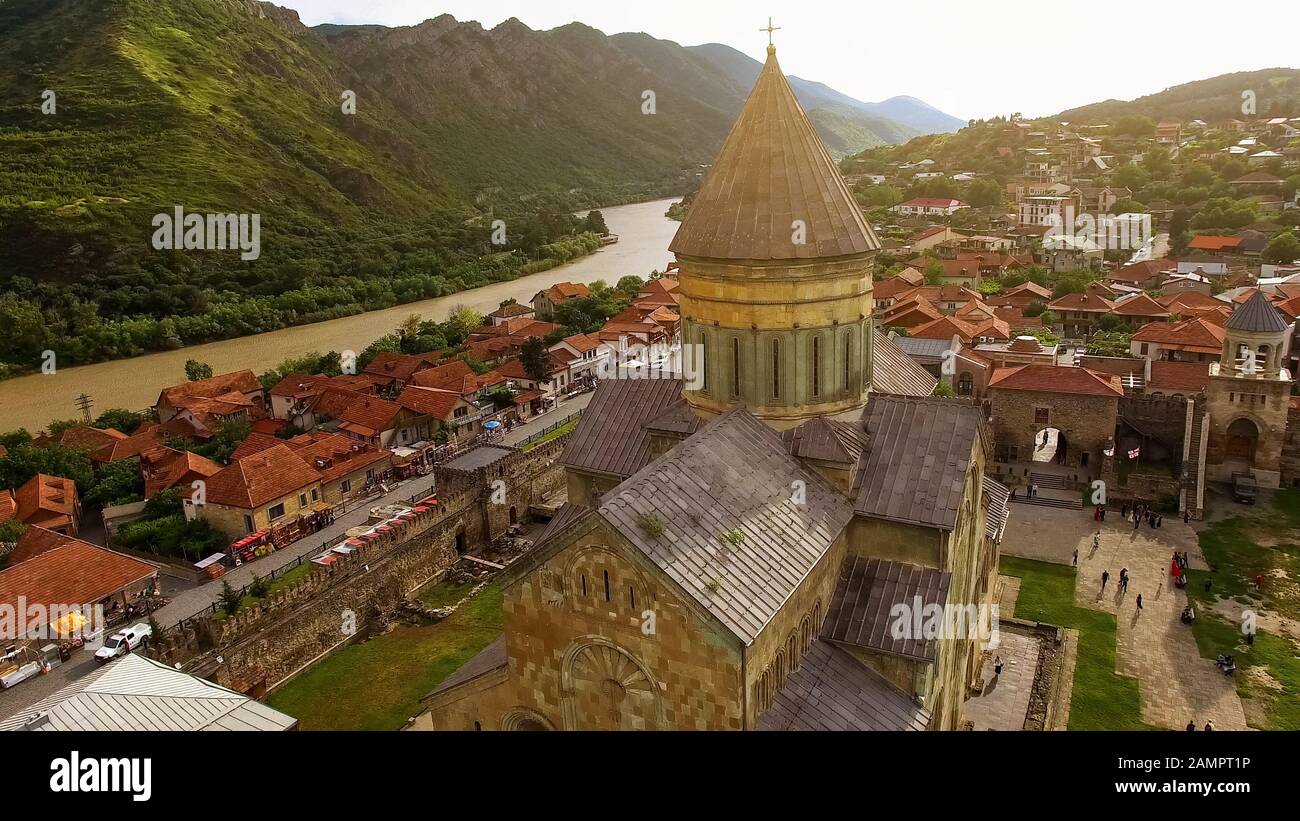Ancient Georgian architecture in green mountain valley with river ...