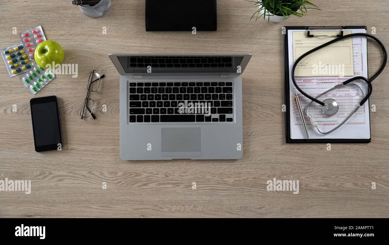 Doctors desktop in modern clinic, consulting patient online on laptop ...