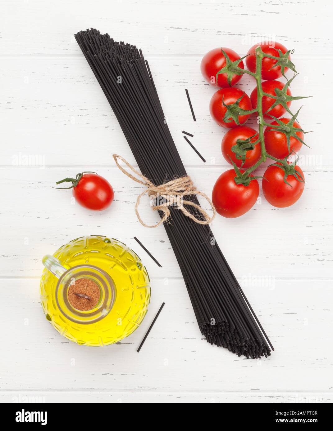Black spaghetti pasta, tomatoes and olive oil. Top view flat lay Stock ...