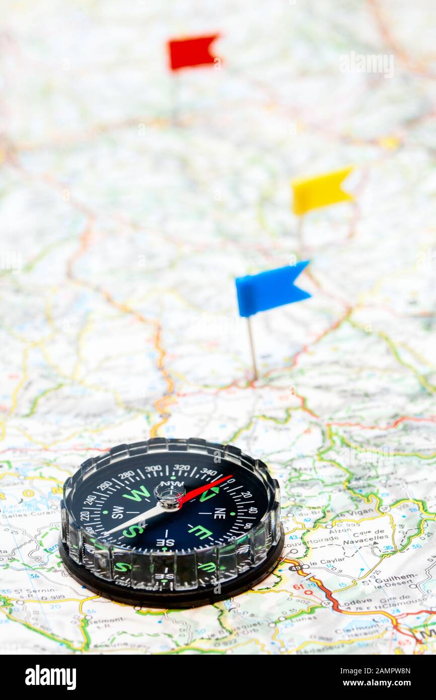 Compass on map with color flag pins Stock Photo - Alamy