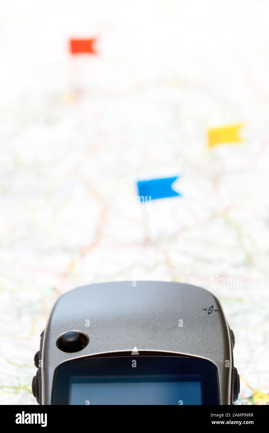 GPS navigator on a map with color flag pins in background Stock Photo ...