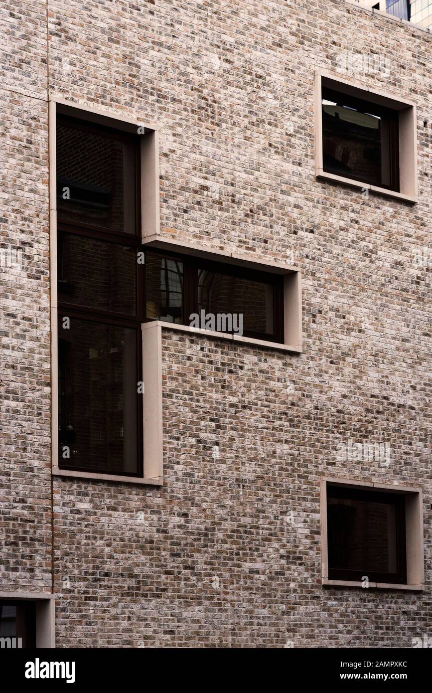 A modern flats / apartment block with irregular geometrical windows ...