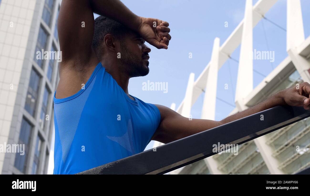 Muscular male tired after running, sweating and breathing hard ...