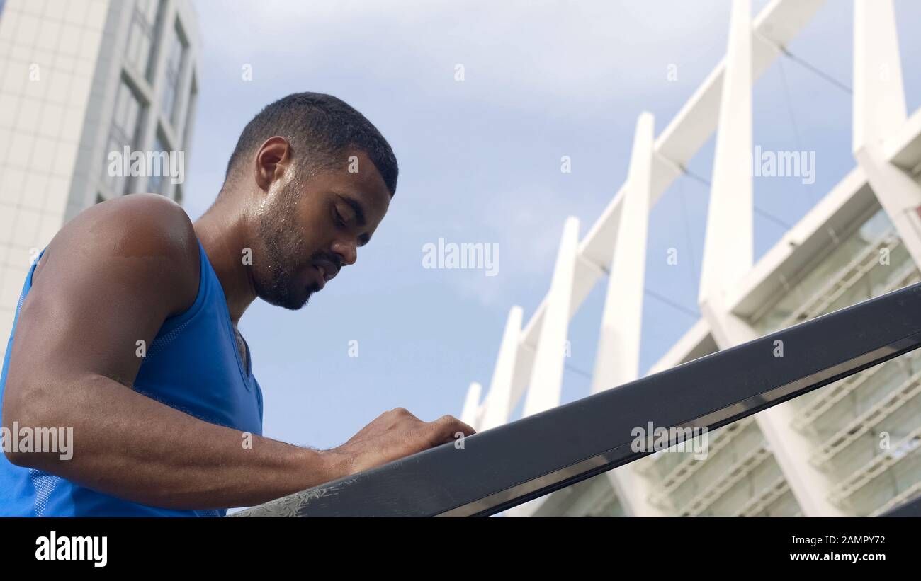 Exhausted athlete breathing heavily after running, overcoming ...