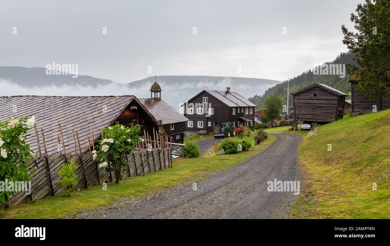 Traditional Norwegian farm with several buildings and clock tower in ...