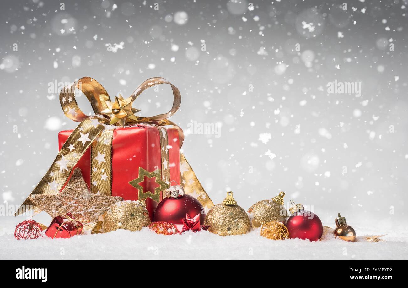 Gift Box and Baubles on Snow with falling Snowflakes - Christmas ...