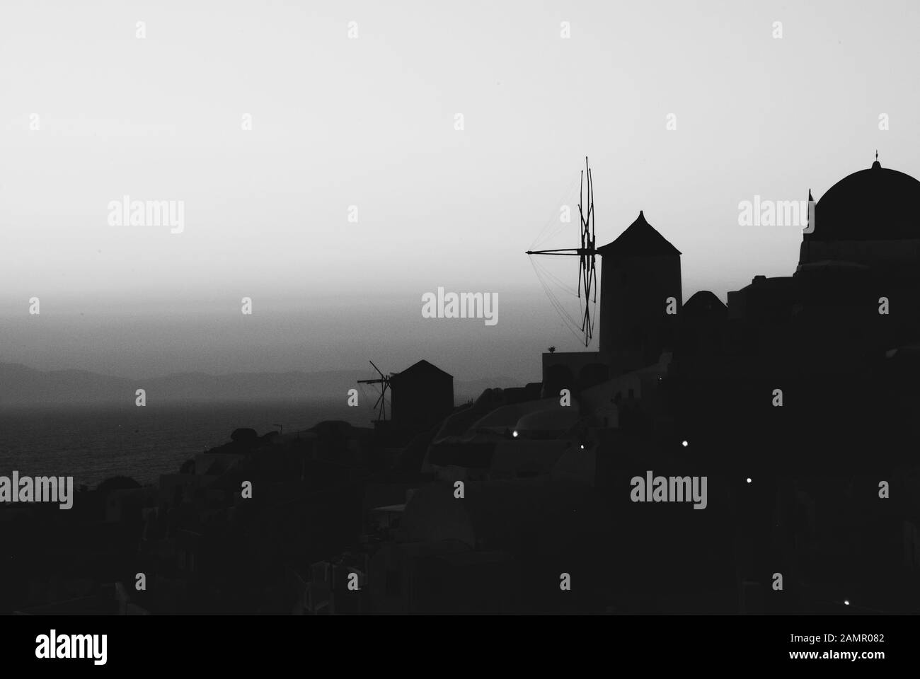 Vintage windmills in the sunset of Oia Stock Photo - Alamy