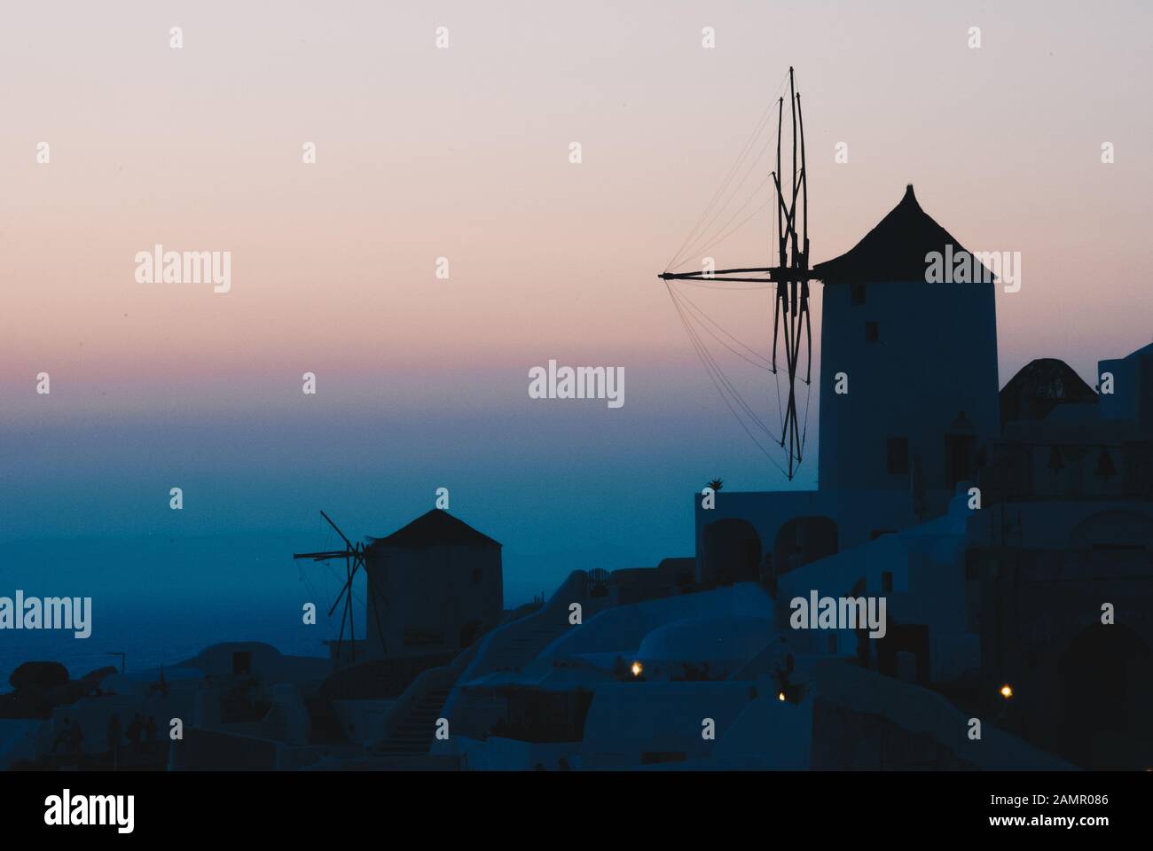 Vintage windmills in the sunset of Oia Stock Photo - Alamy