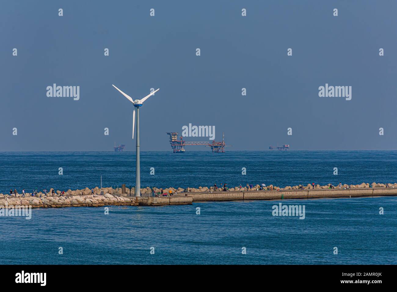 Wind Mill on Breakwater Stock Photo - Alamy