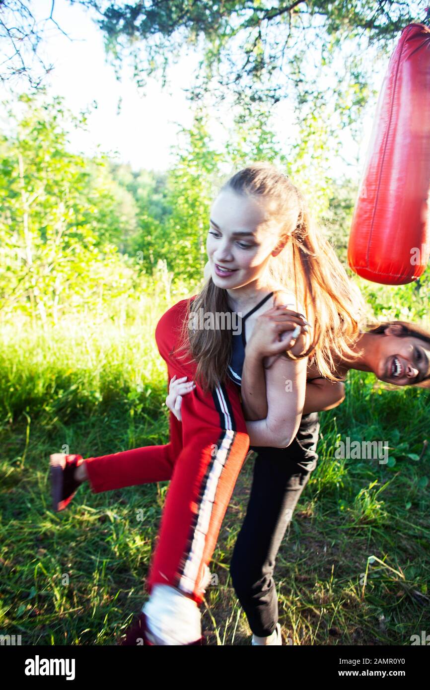 two diverse nations girls fighting boxing outside in green park, sport ...