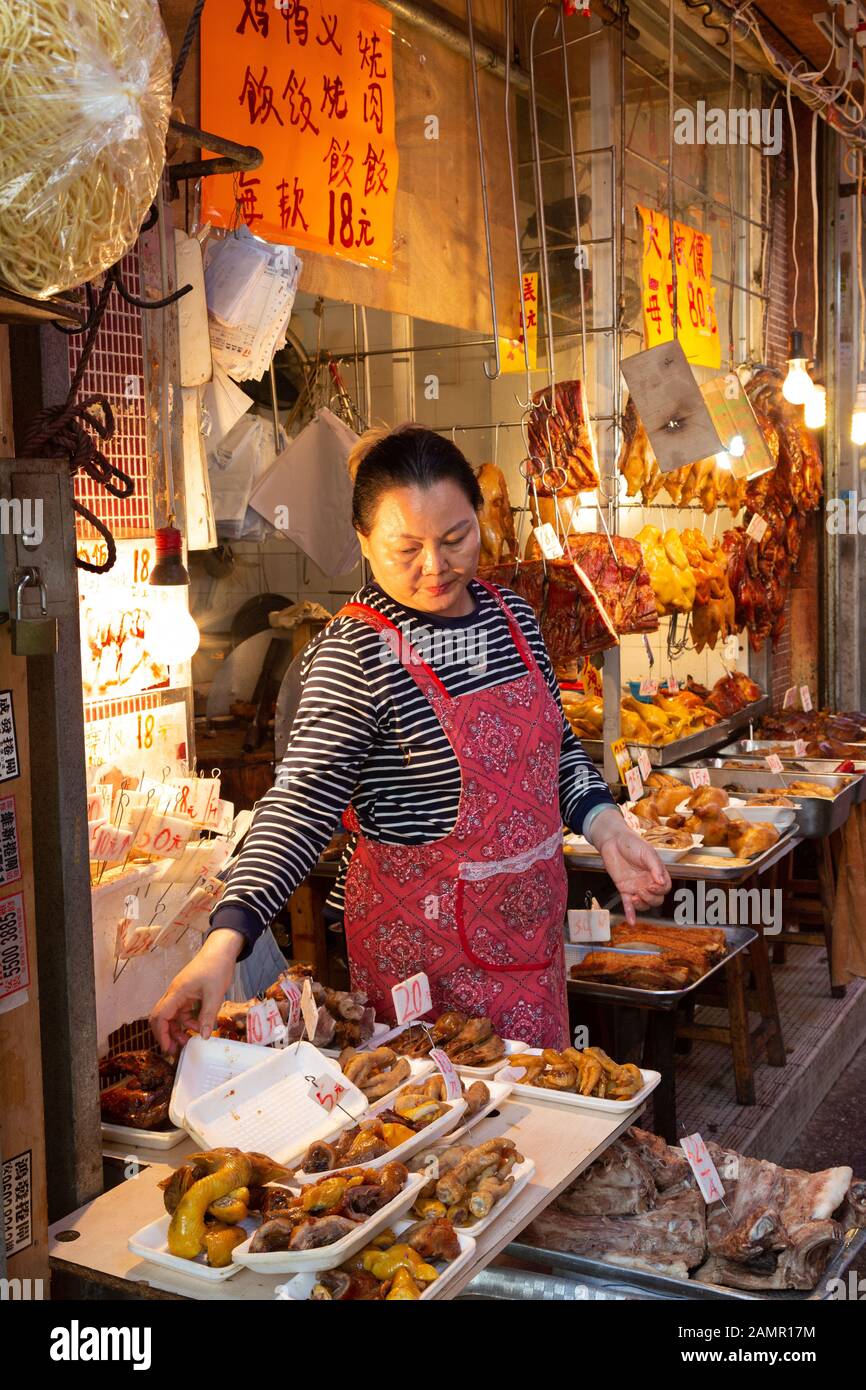 Hong Kong meat and poultry butcher; the vendor and her wares in a ...