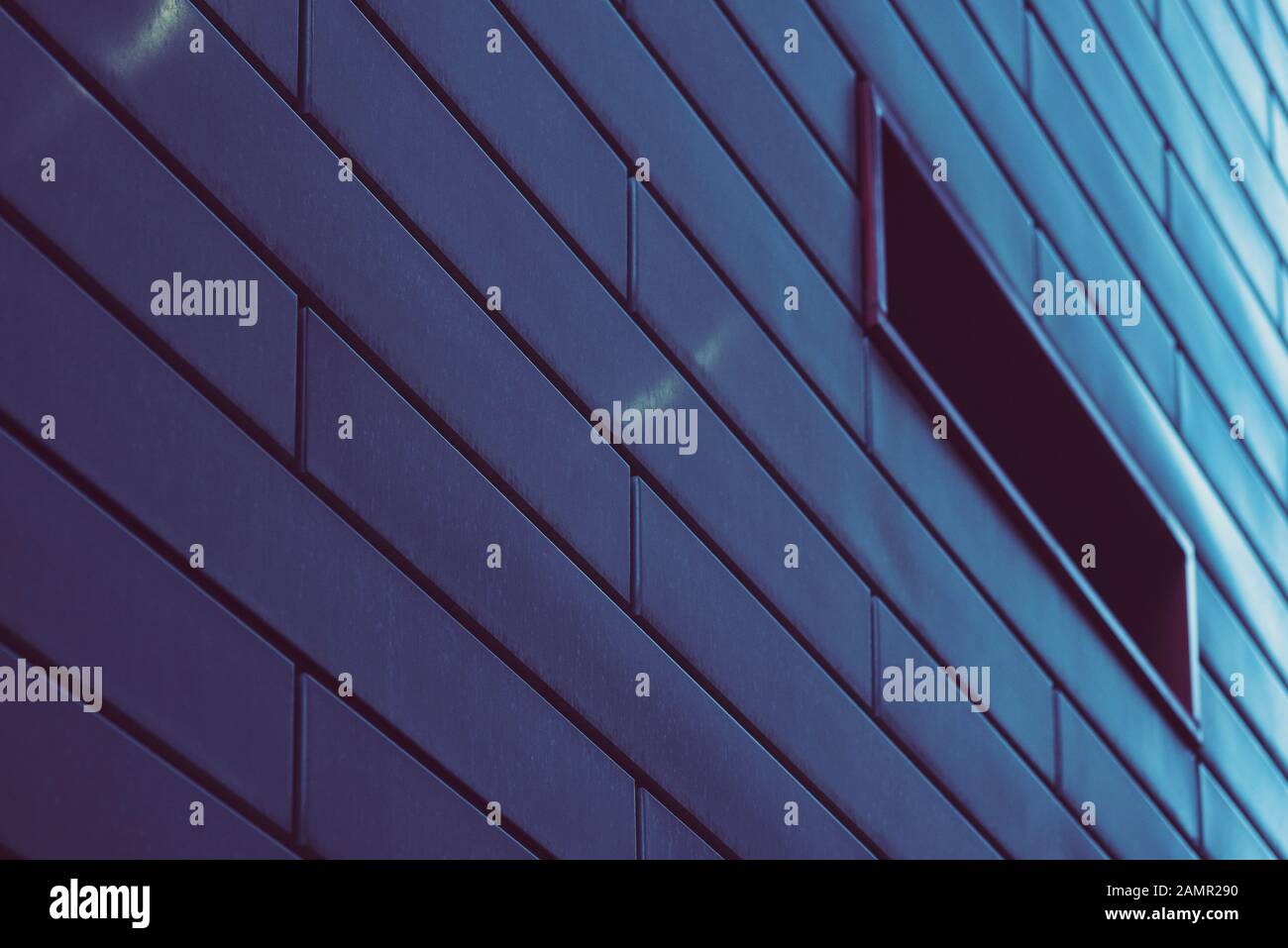 Metal siding / cladding panels laid in a brickwork pattern with a ...