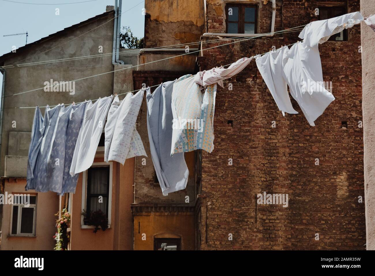 Laundry hanging from a rope in the street Stock Photo - Alamy