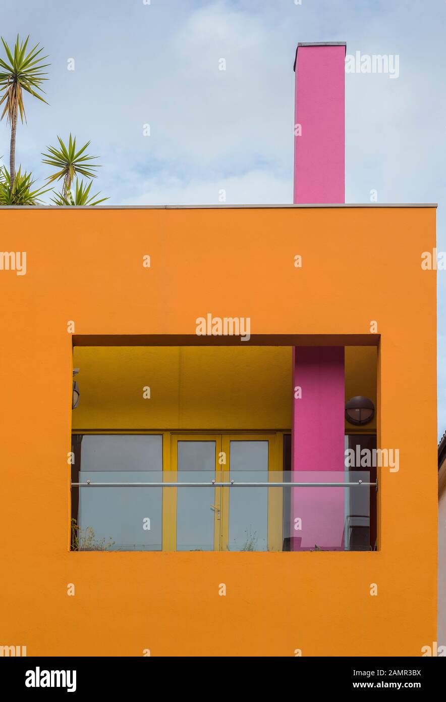 Modern architecture with bright orange building with yellow and pink ...