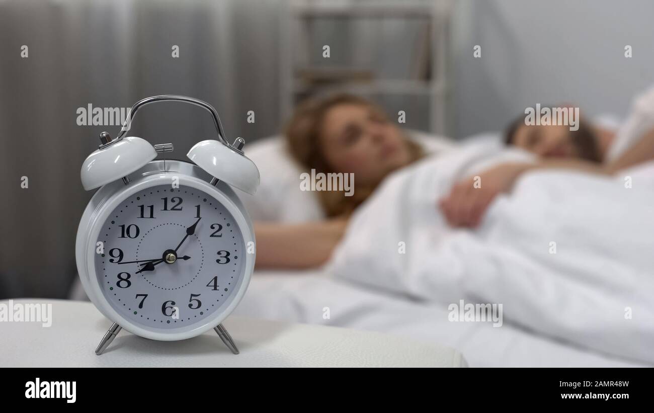 Couple alarm clock sleeping hi-res stock photography and images - Alamy