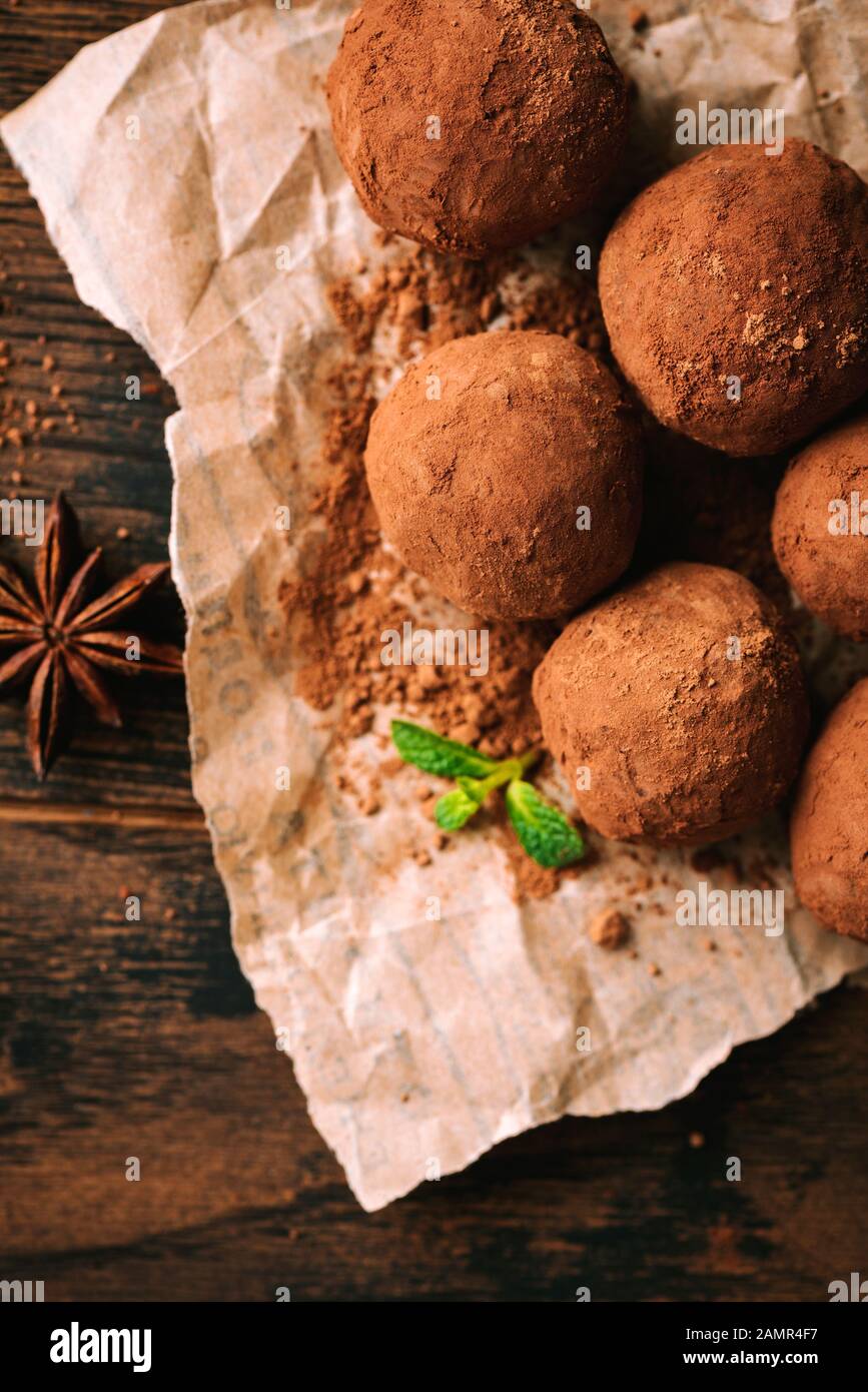 Homemade dark chocolate truffles on parchment paper, top view. Sweet ...